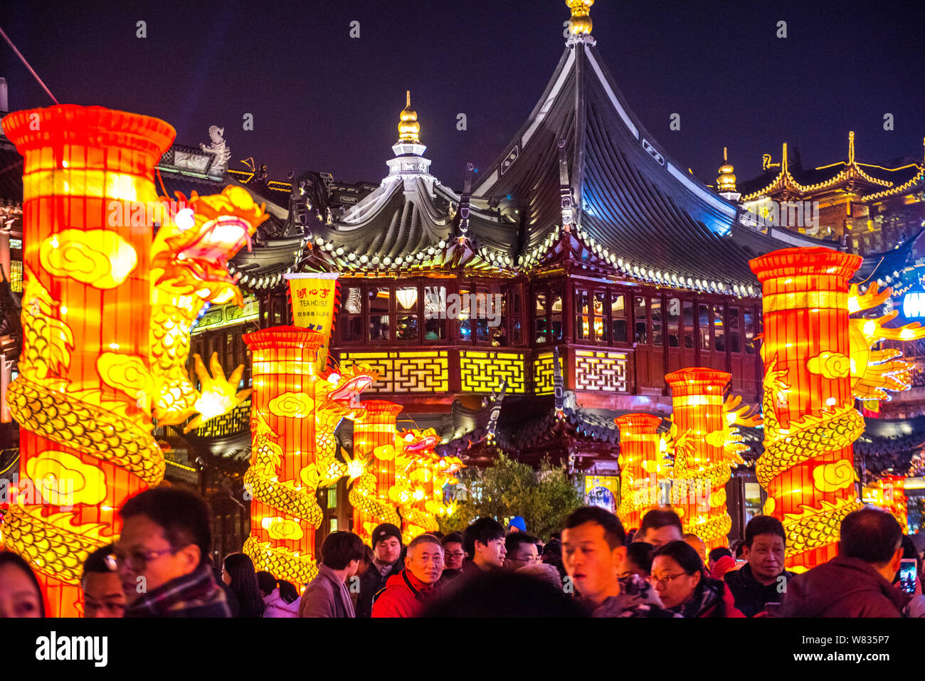 Visitors look at illuminated lanterns for the Chinese Lunar New Year ...