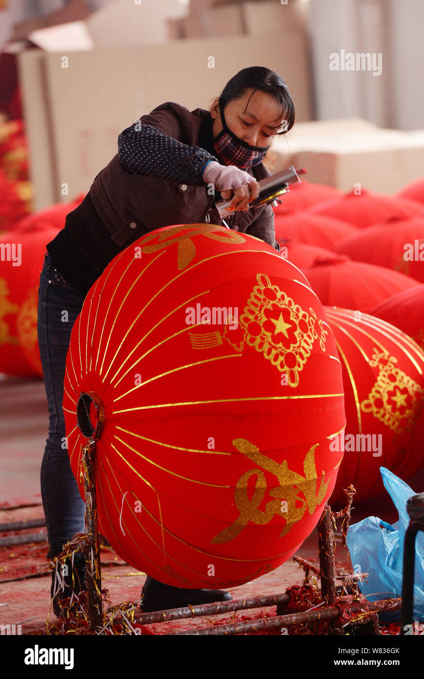 A Chinese worker makes red lanterns for the upcoming Chinese New Year ...