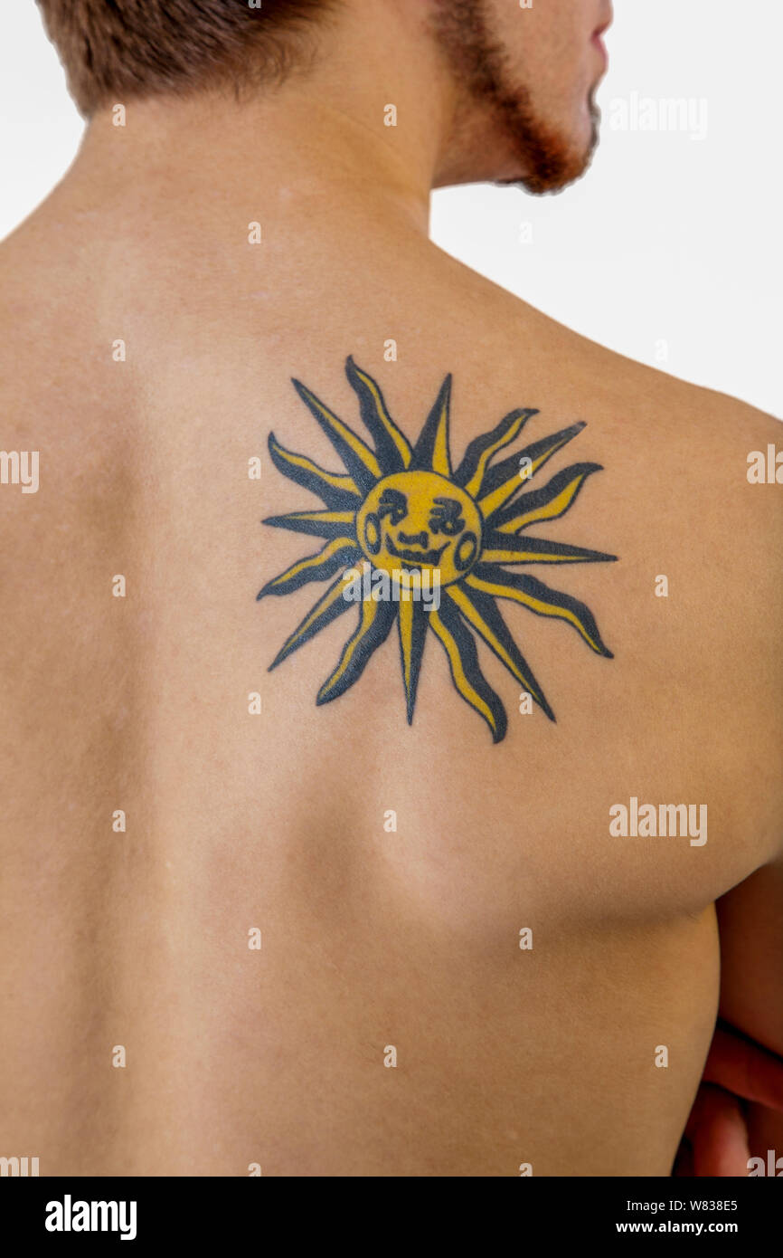 Young man with a stylized sun on his back Stock Photo - Alamy