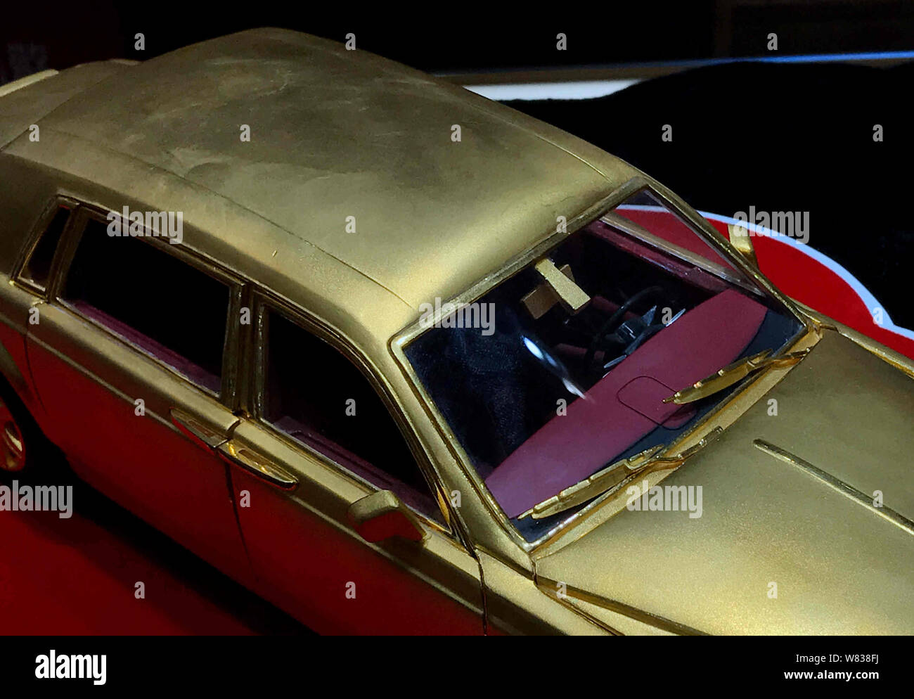 A gold model of Rolls-Royce Phantom luxury car is on display during a ...