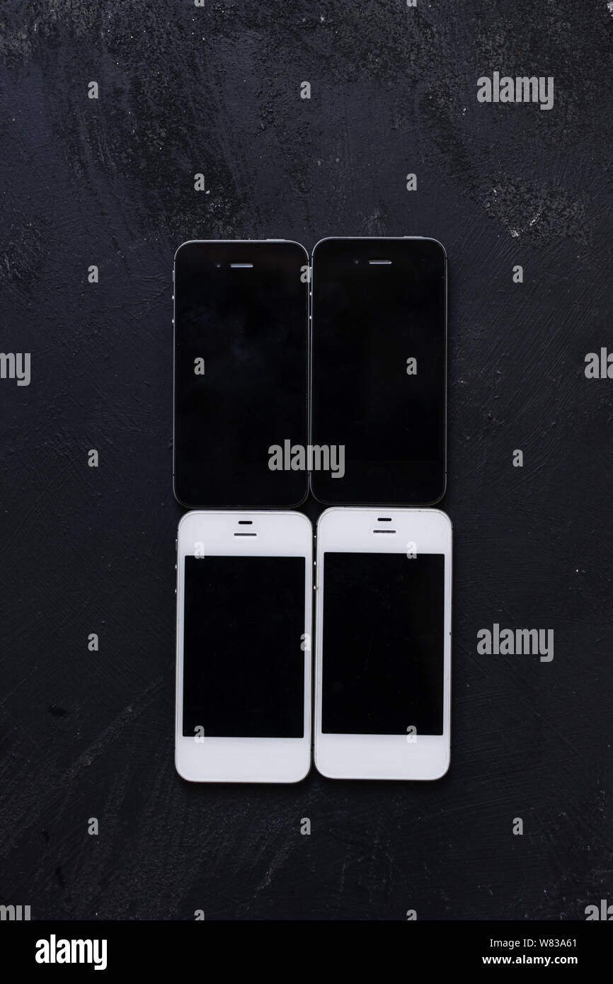 collection of old phones on black background, obsolete cracked ...