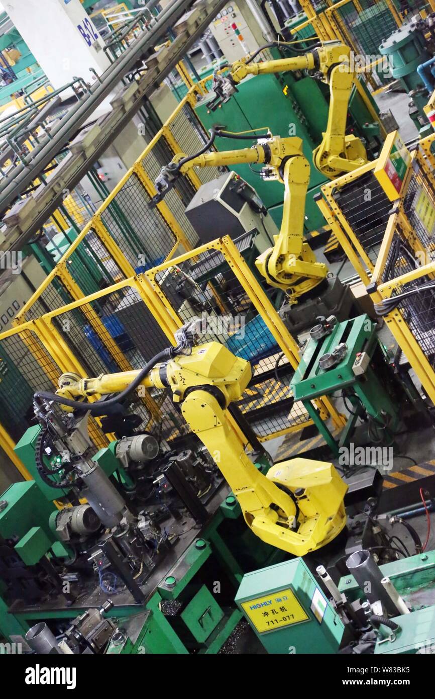 --FILE--Robot arms are used to deliver polished compressor shells to ...