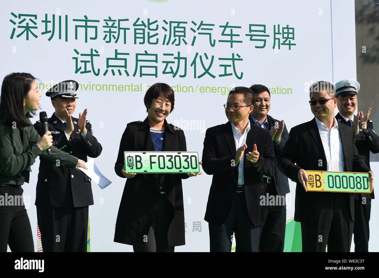 The Chinese owner, third left, of a Tang plug-in hybrid SUV of BYD, and ...