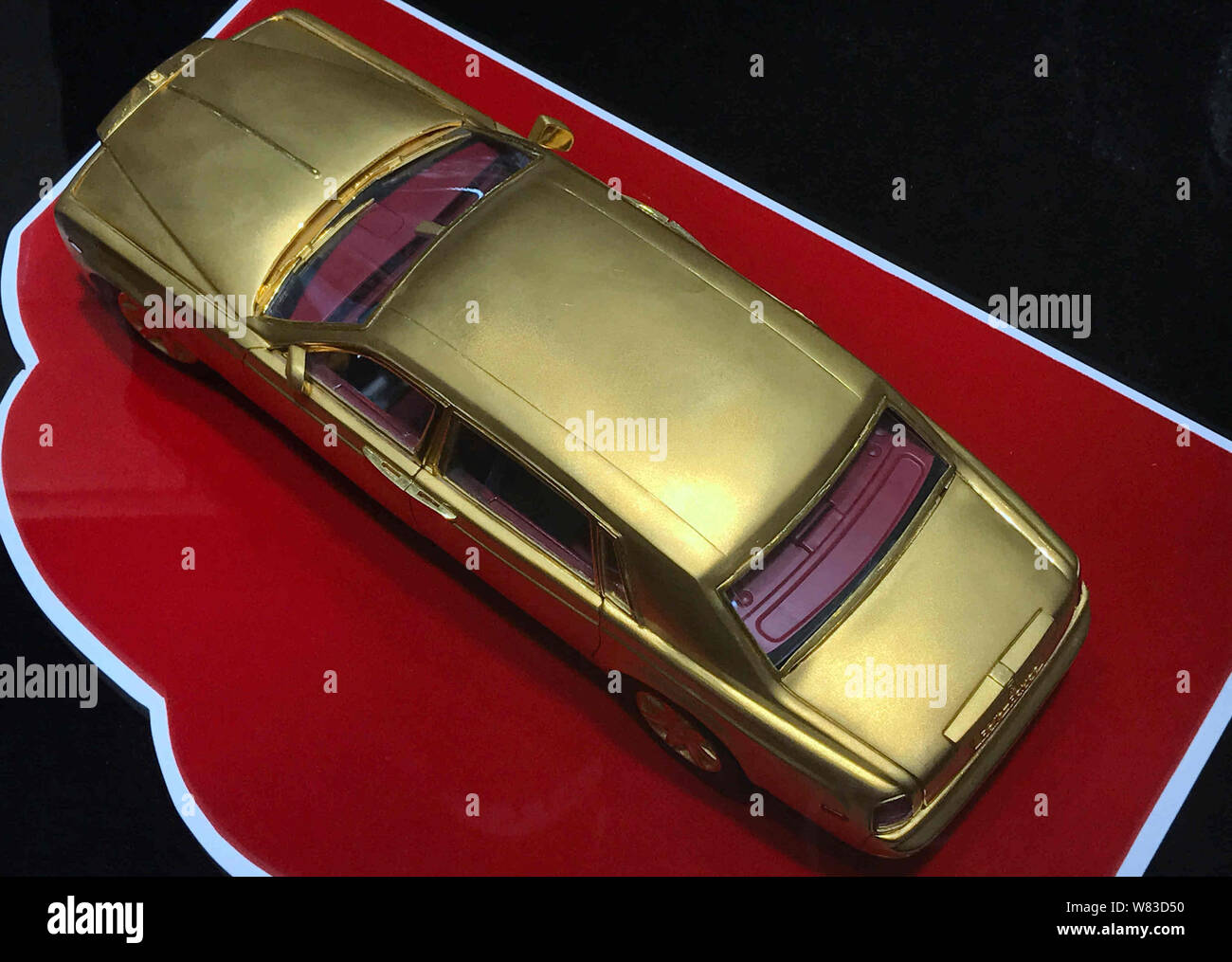 A gold model of Rolls-Royce Phantom luxury car is on display during a ...