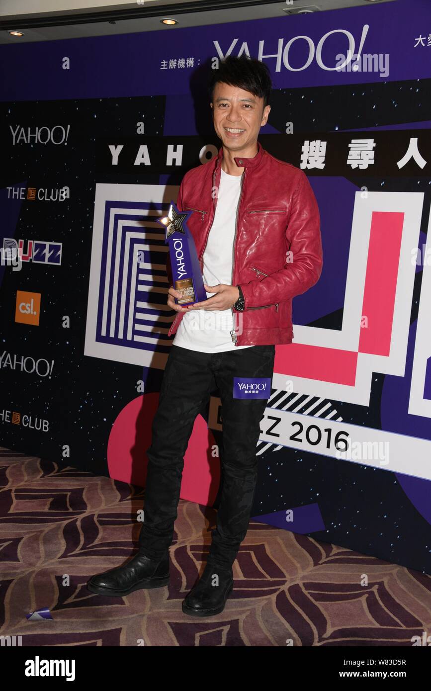 Hong Kong singer Hacken Lee poses with his trophy during the ...