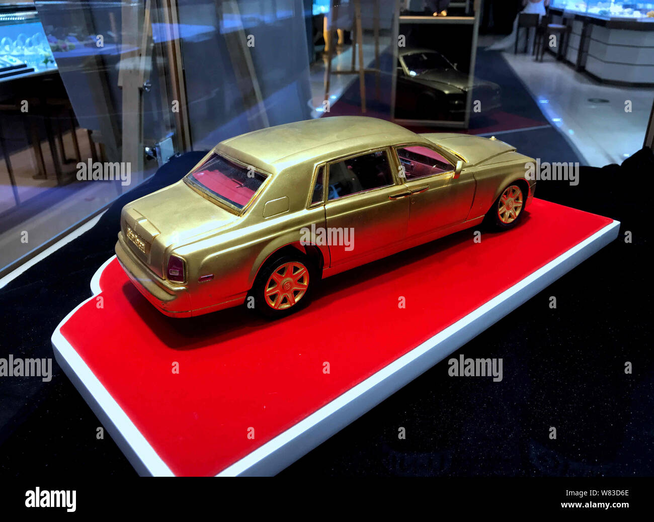 A gold model of Rolls-Royce Phantom luxury car is on display during a ...