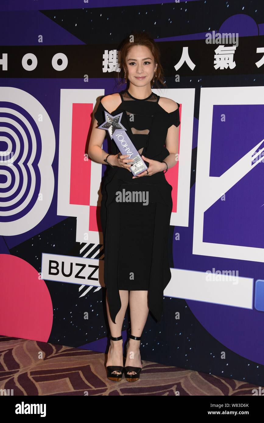 Singer and actress Gillian Chung of Hong Kong pop duo Twins poses with her trophy during the ...