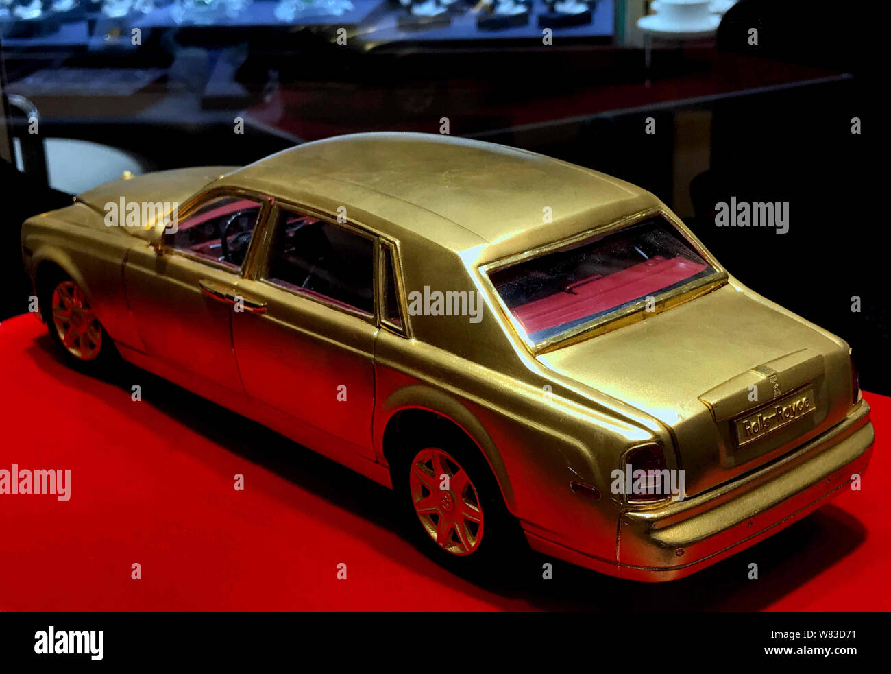 A gold model of Rolls-Royce Phantom luxury car is on display during a ...