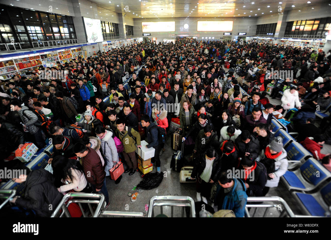 --FILE--A crowd of Chinese passengers queue up at the Beijing West ...