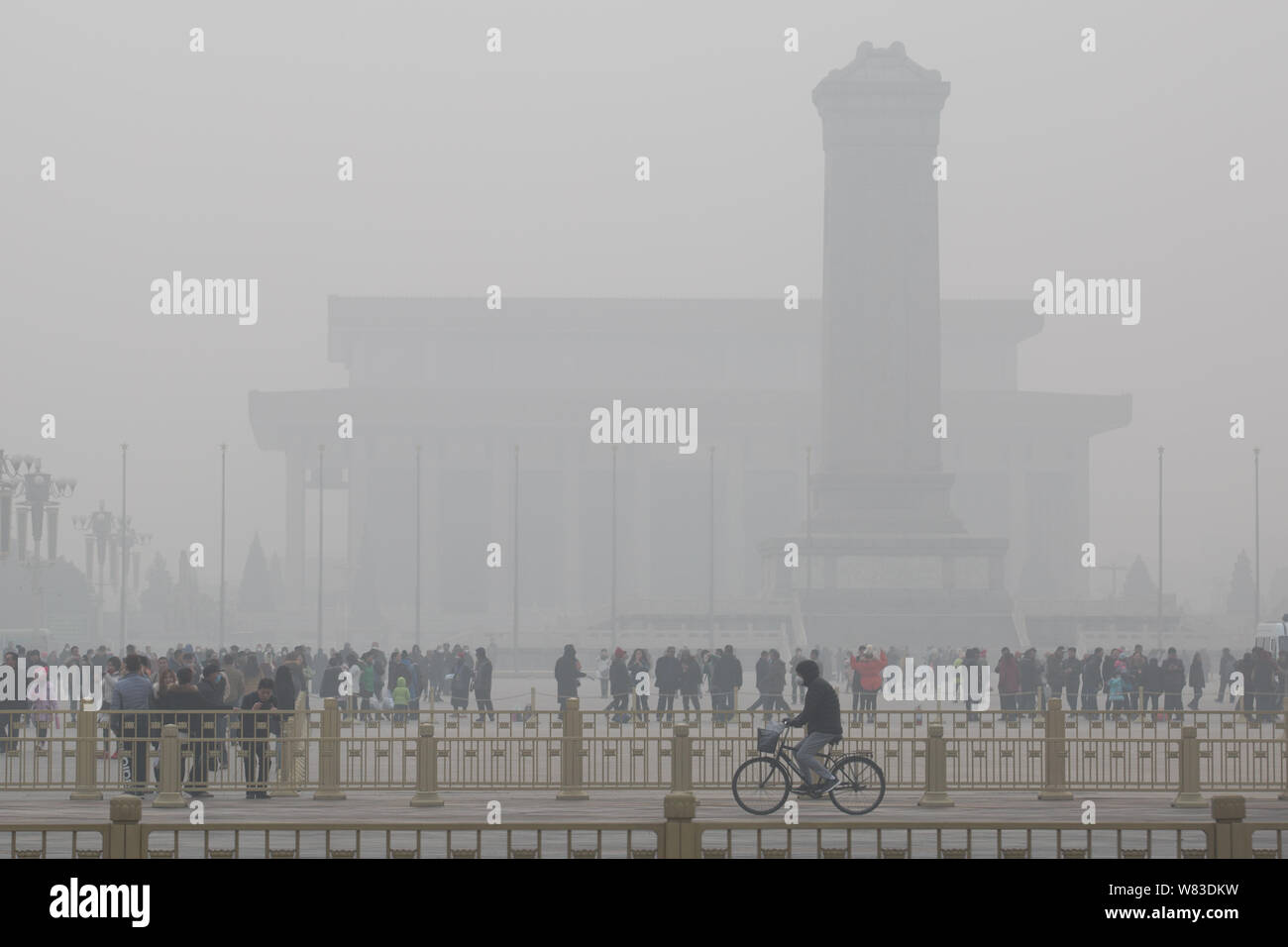 Tourists visit the Tiananmen Square in heavy smog in Beijing, China, 20 ...