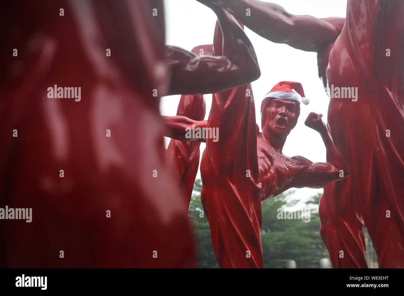 Red Bruce Lee sculptures dressed as Santa Claus are pictured outside a ...