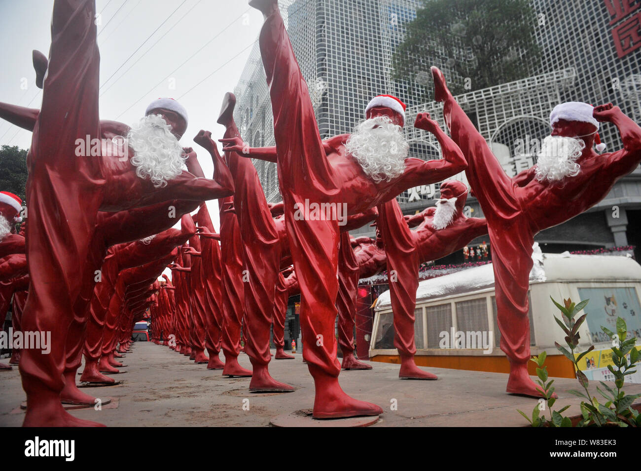 Red Bruce Lee sculptures dressed as Santa Claus are pictured outside a ...