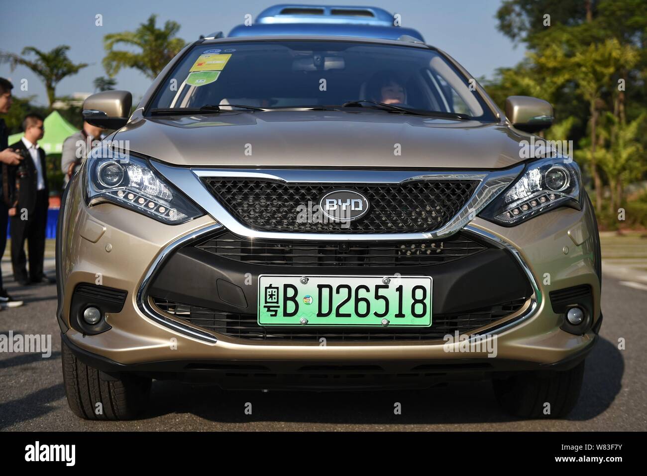 A Chinese woman drives her Tang plug-in hybrid SUV of BYD installed ...