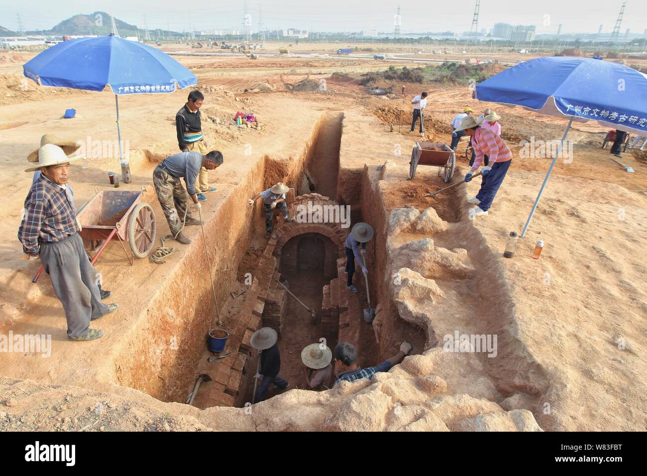Chinese archaeologists excavate one of the 25 ancient tombs spanning ...