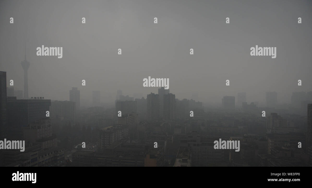 High-rise buildings are seen vaguely in heavy smog in Chengdu city ...