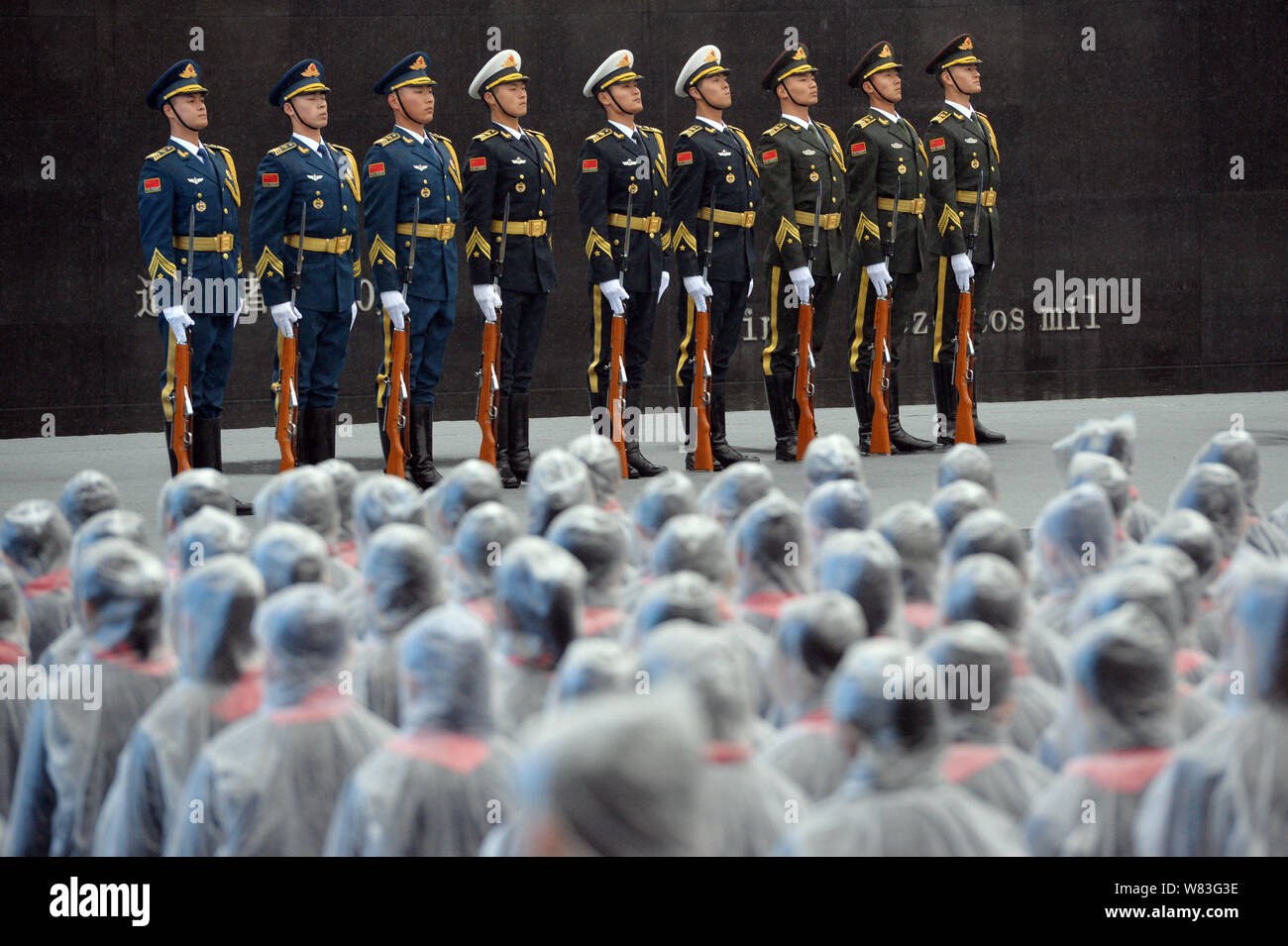 Chinese People's Liberation Army officers stand guard as local ...