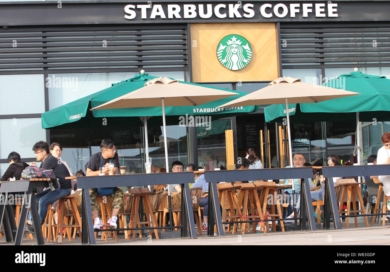 --FILE--Chinese customers enjoy coffee at a cafe of Starbucks Coffee in ...