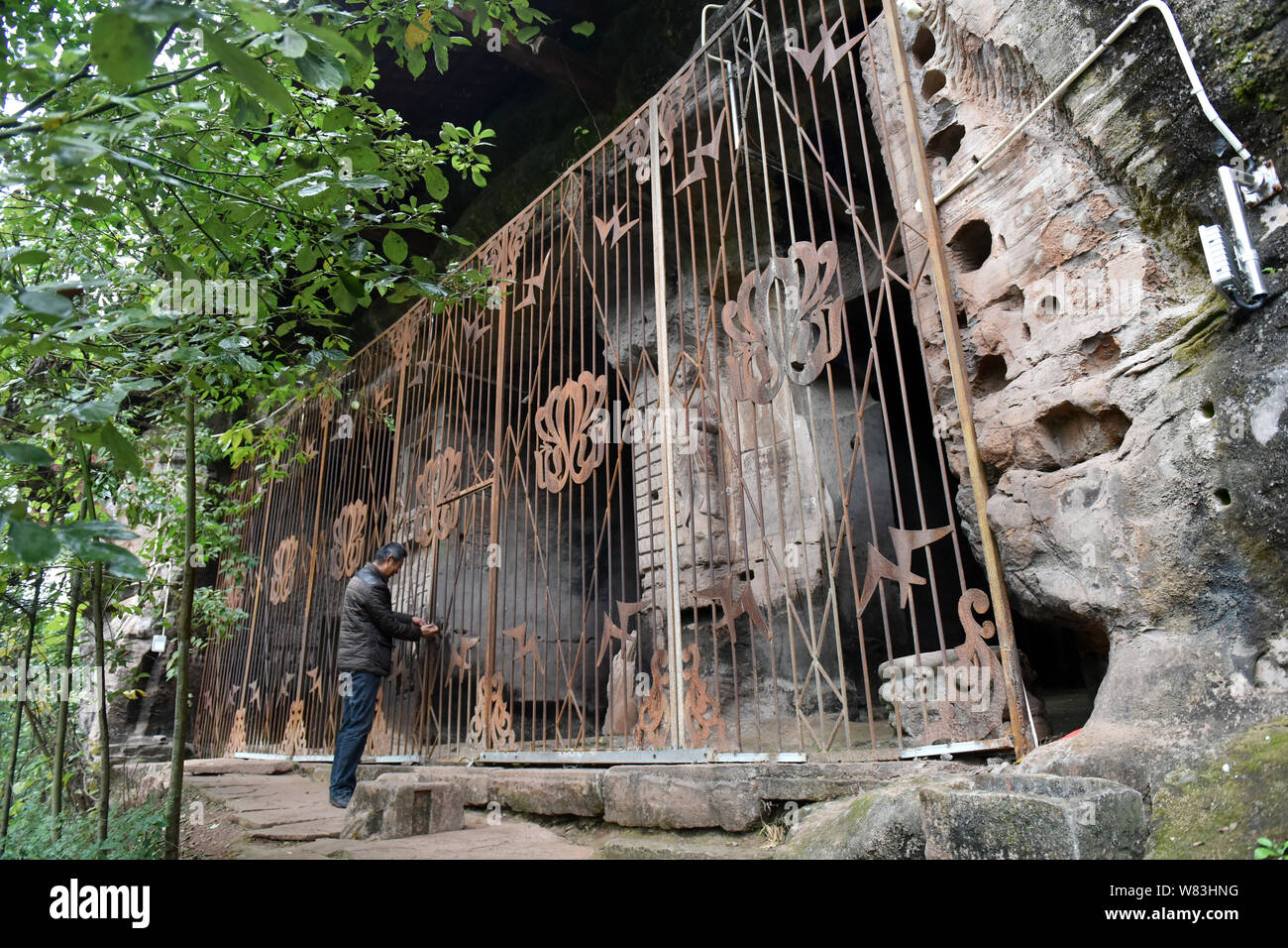 A Chinese worker locks the site of hidden Buddhist sutras in a stone ...