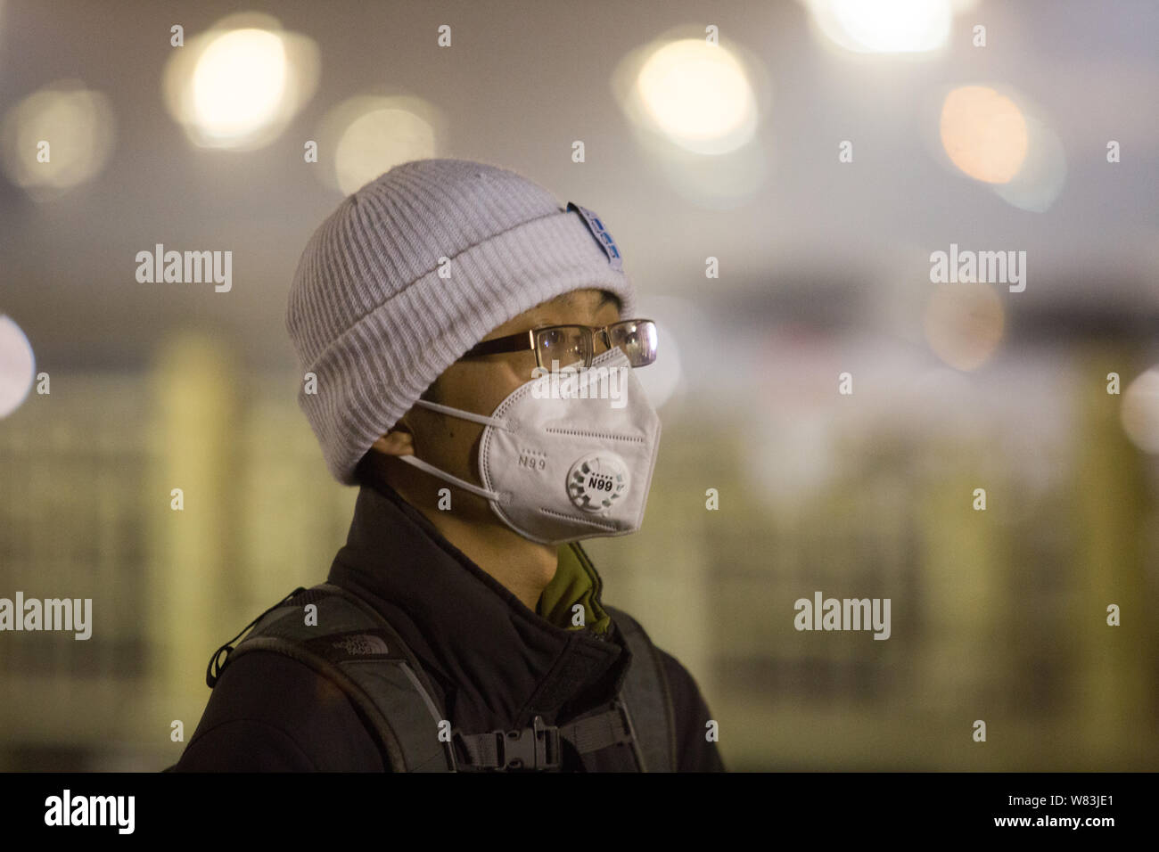 A tourist wearing a face mask against air pollution visits the ...