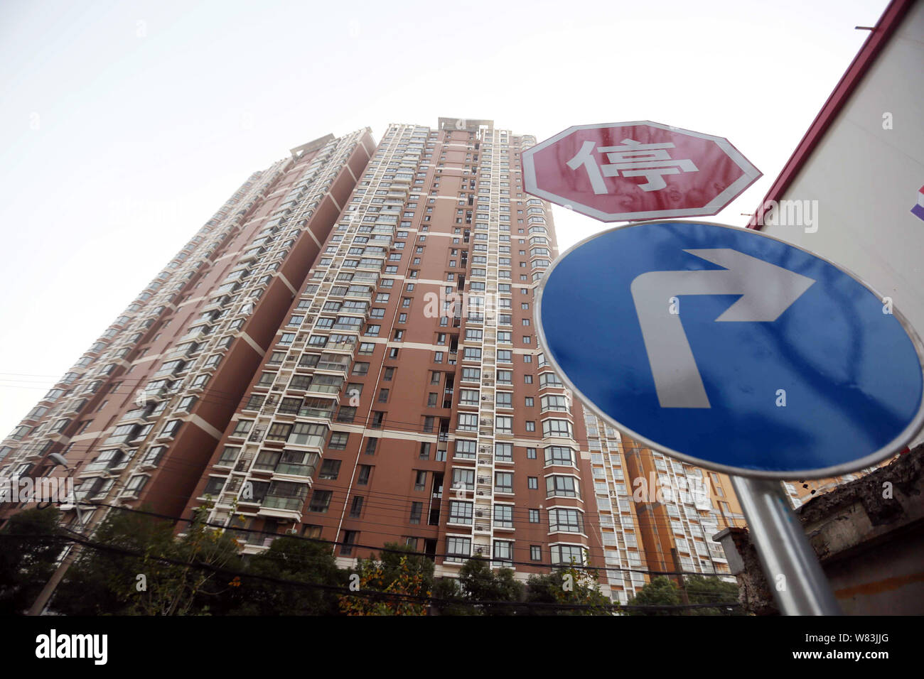 --FILE--Stop and right-turn signs are displayed in front of high-rise ...