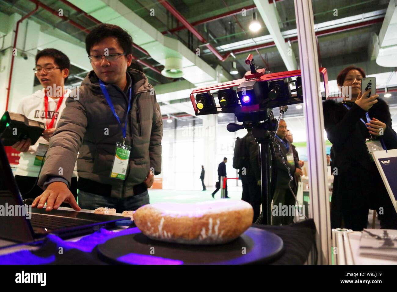 A hand-held monocular 3D scanner is on display during the Inside 3D ...