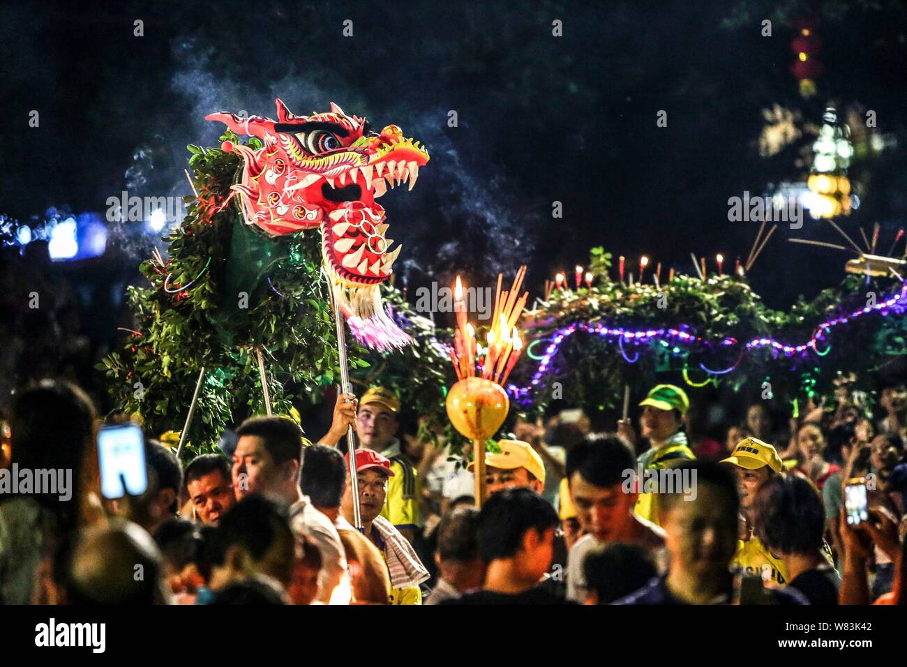 Chinese entertainers perform a fire dragon dance to celebrate the Mid ...
