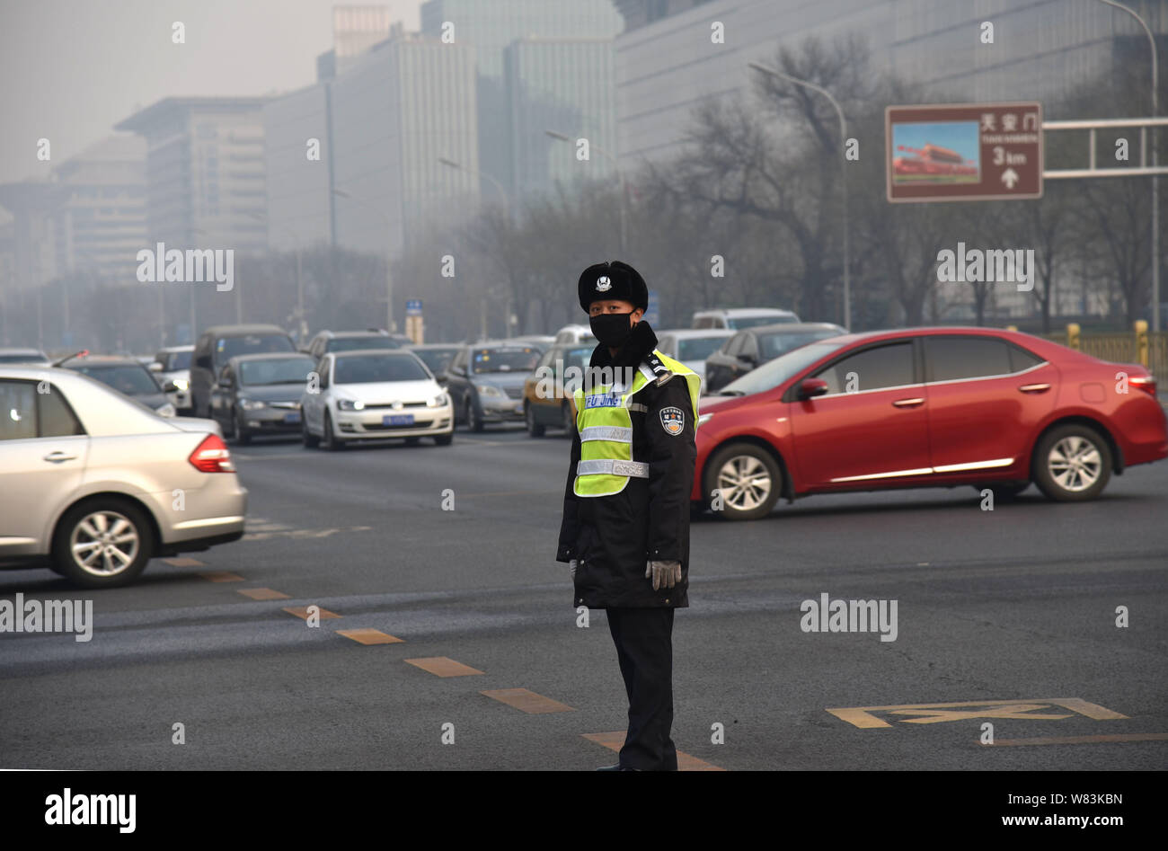 A police officer wearing a face mask against air pollution directs ...