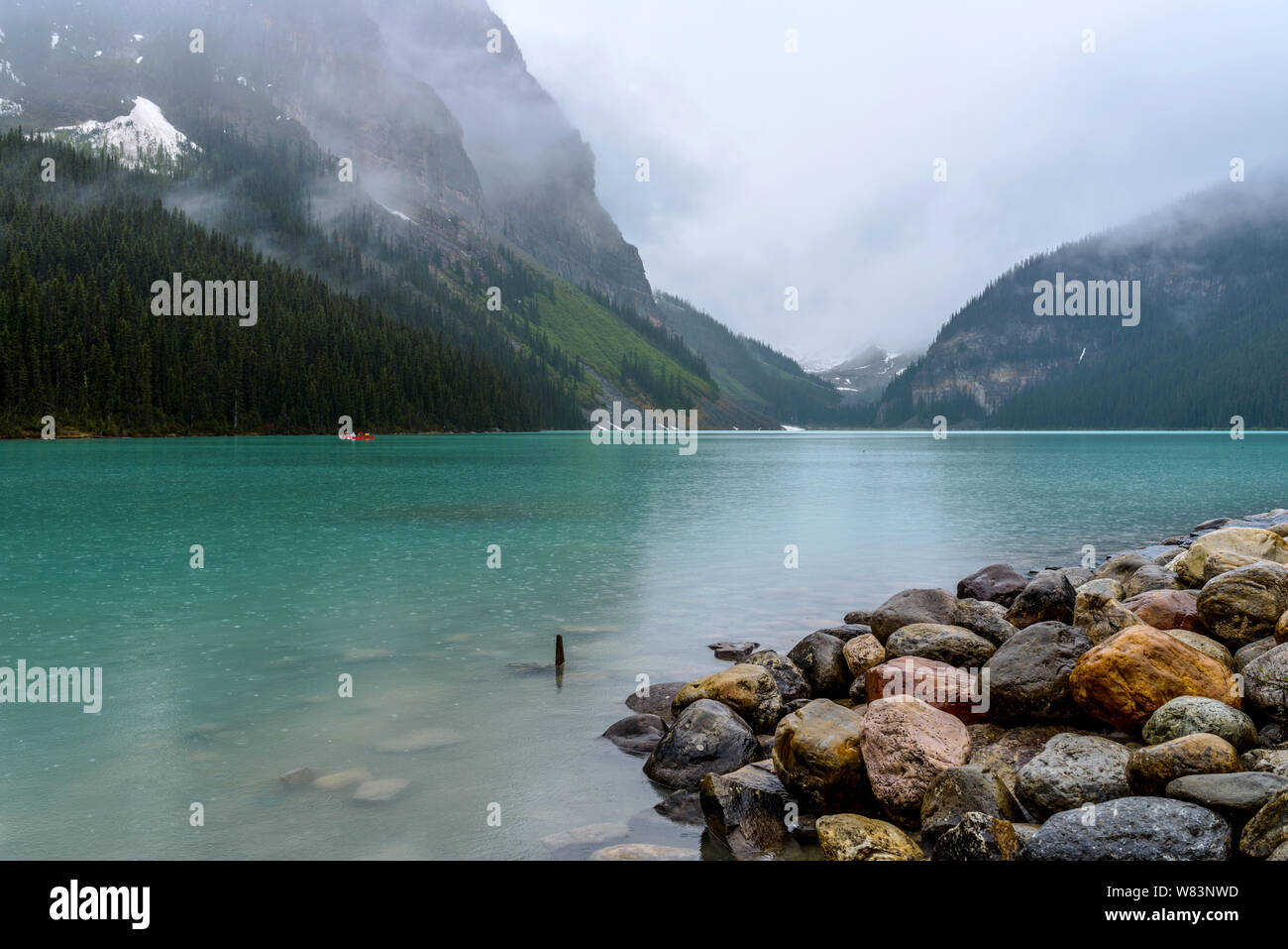 Spring at Lake Louise - A stormy and foggy Spring day view of colorful ...