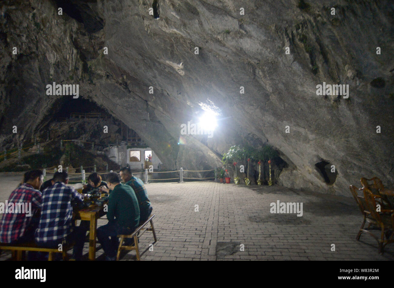 Customers eat dinner at a restaurant built in a karst cave in Chenzhou ...