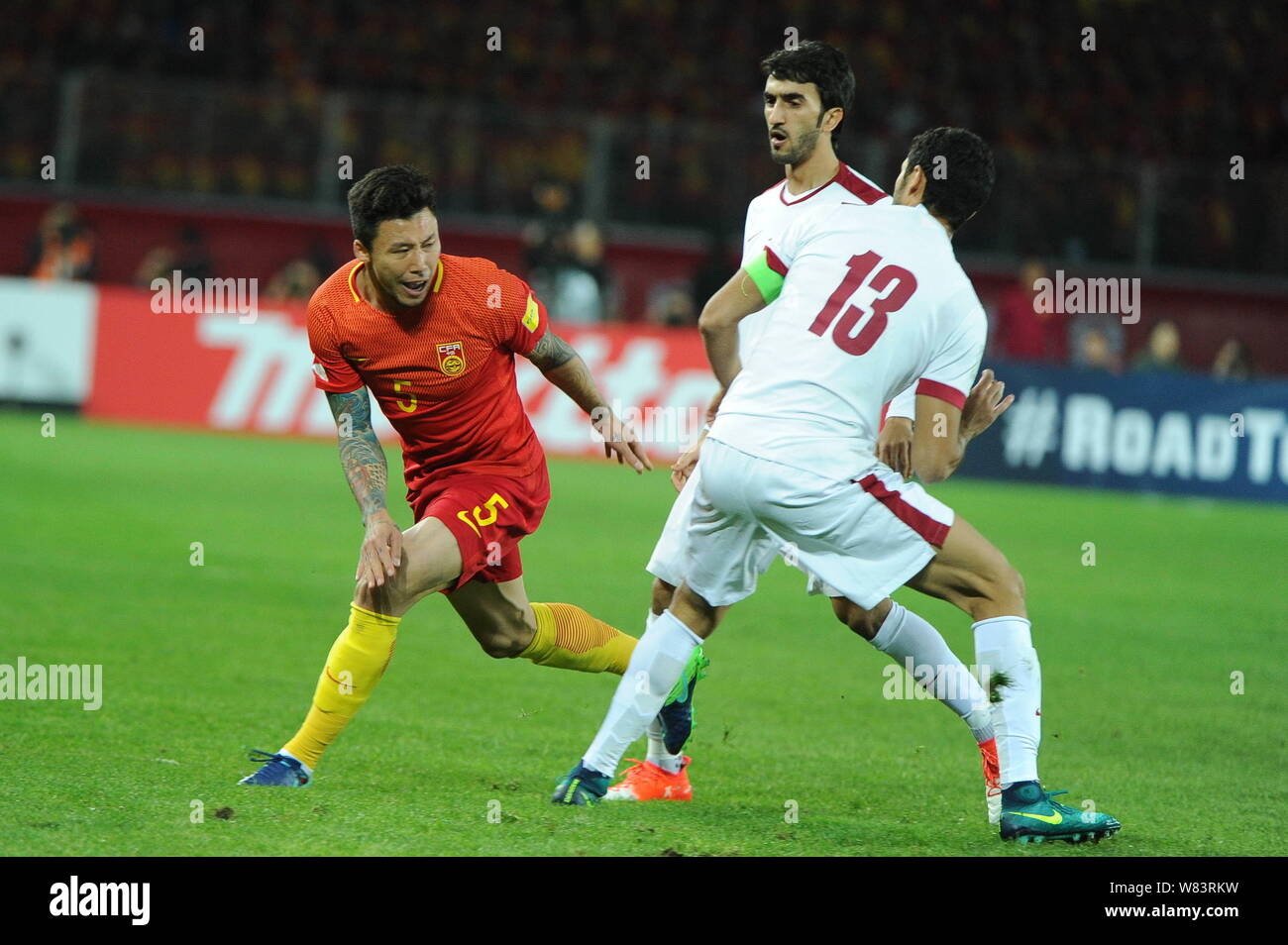Zhang Linpeng of China, left, challenges players of Qatar in their ...