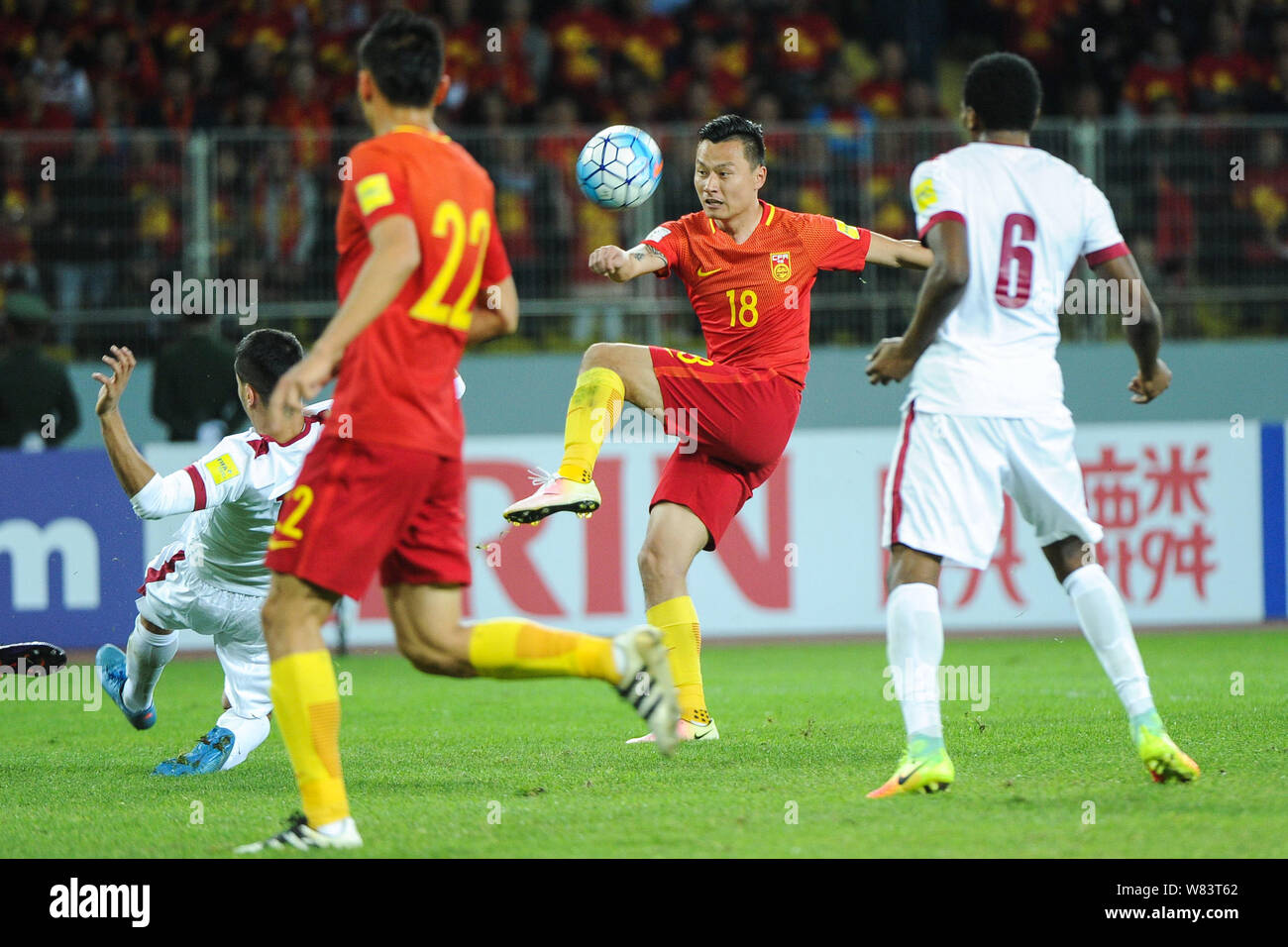 Gao Lin of China, center, challenges a player of Qatar in their Group A ...