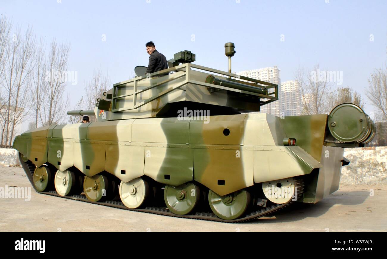 Chinese worker Li Zhikang poses on a replica of Chinese PLA's (People's ...