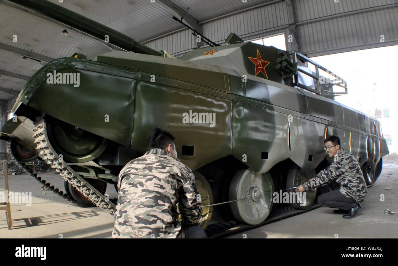 Chinese workers Xing Zhizhen, right, and Li Zhikang measure the length ...