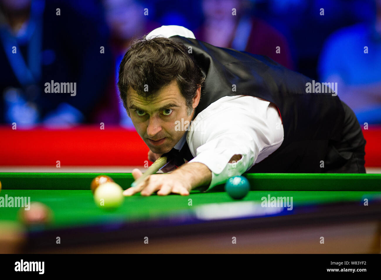 Ronnie O'Sullivan of England plays a shot against John Higgins of ...