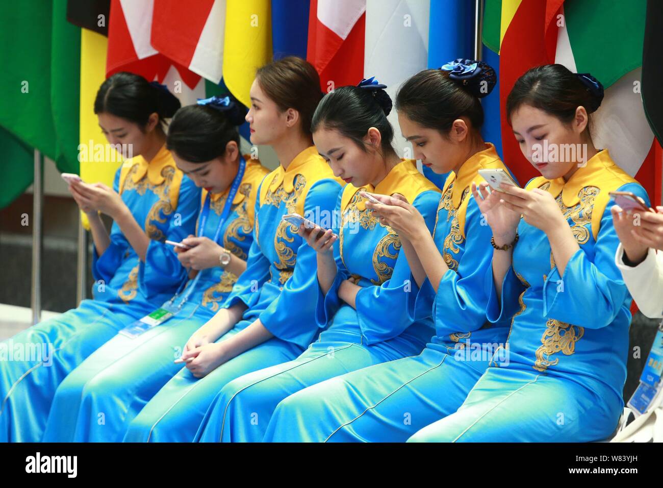 Chinese hostesses use their smartphones during the 3rd World Internet ...