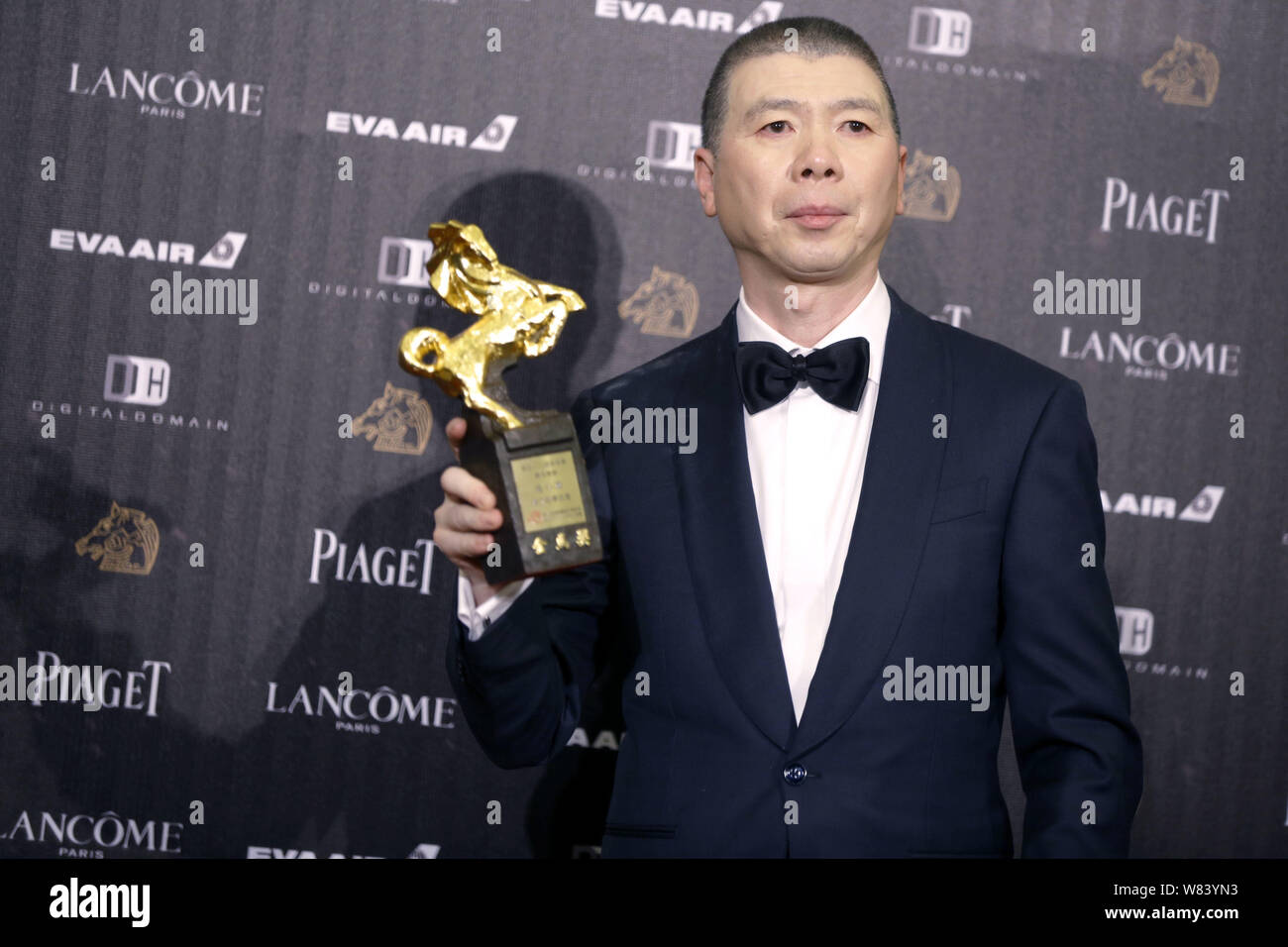 Chinese director Feng Xiaogang poses with his trophy of the Best ...
