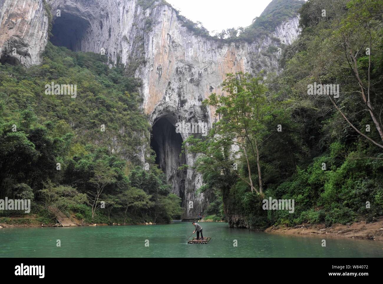 Chinese man Huang Xiaobao of Miao ethnic minority rows a bamboo raft on ...