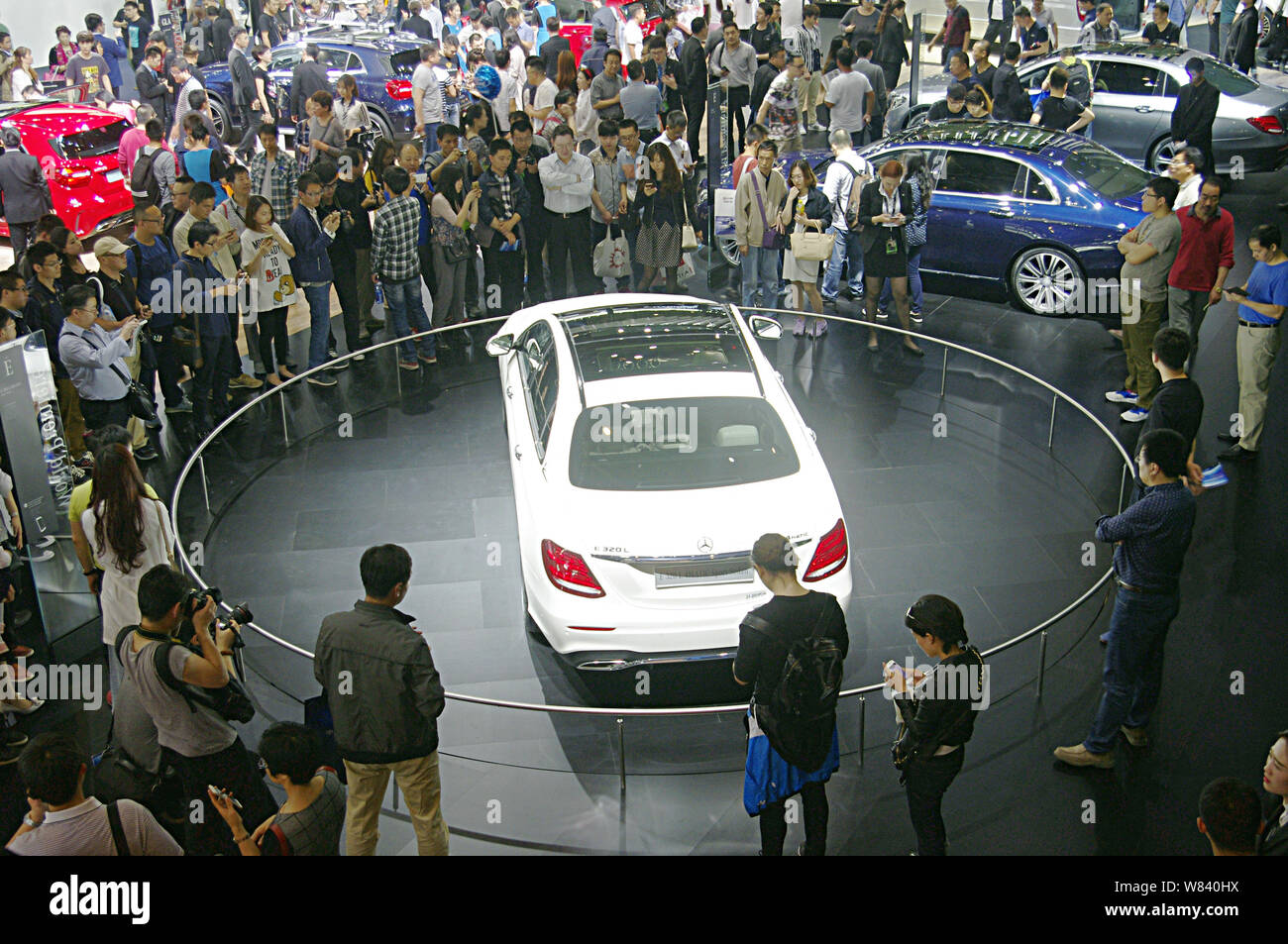 --FILE--Visitors look at a Mercedes-Benz E320L 4MATIC Sport Sedan during the 14th Beijing ...