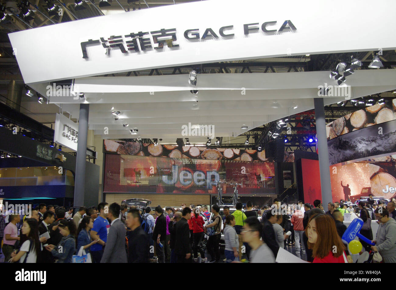 --FILE--Visitors crowd the stand of GAC FCA during the 14th Beijing ...