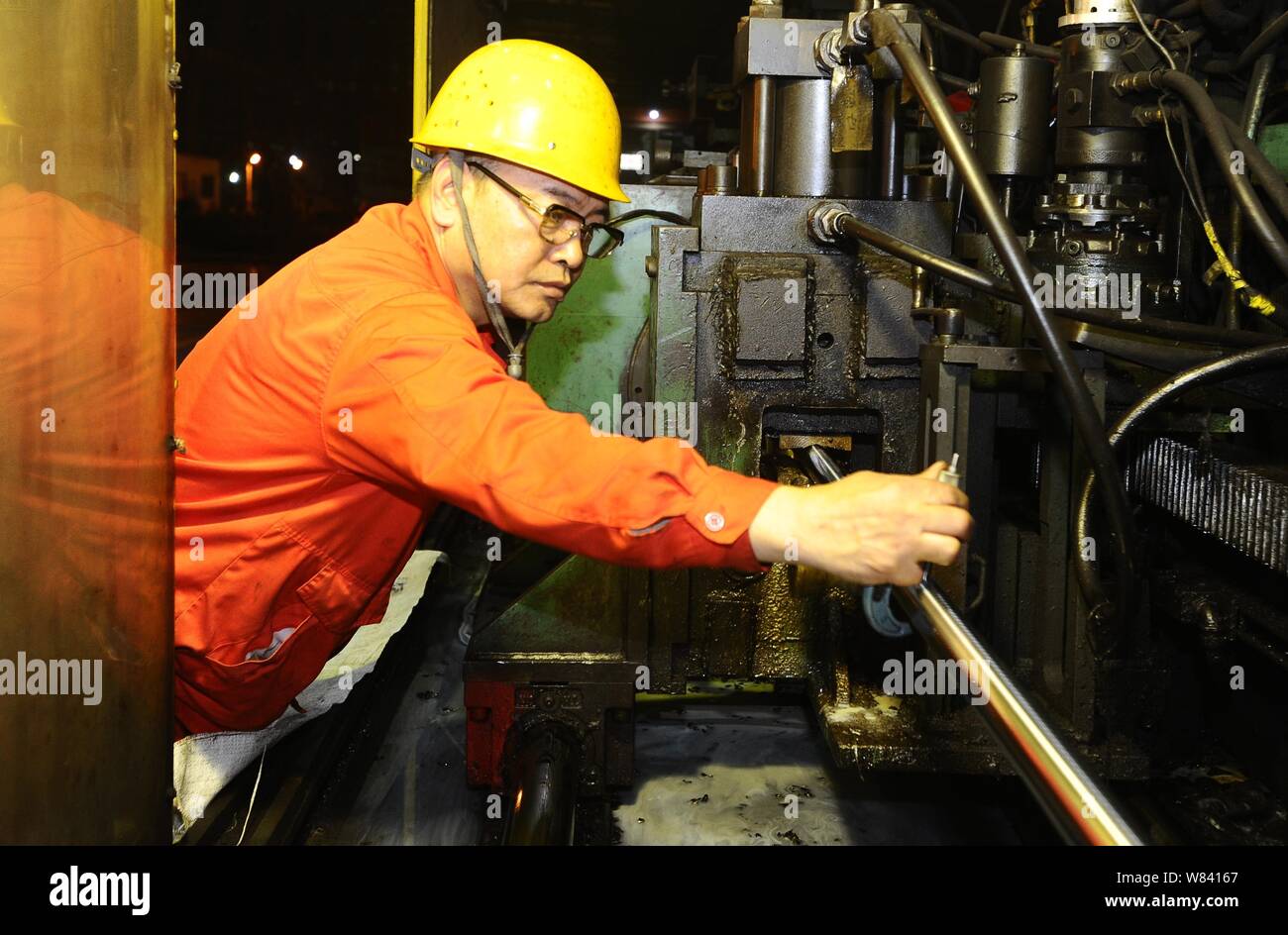 A Chinese worker checks steel products at a steel plant of Dongbei ...