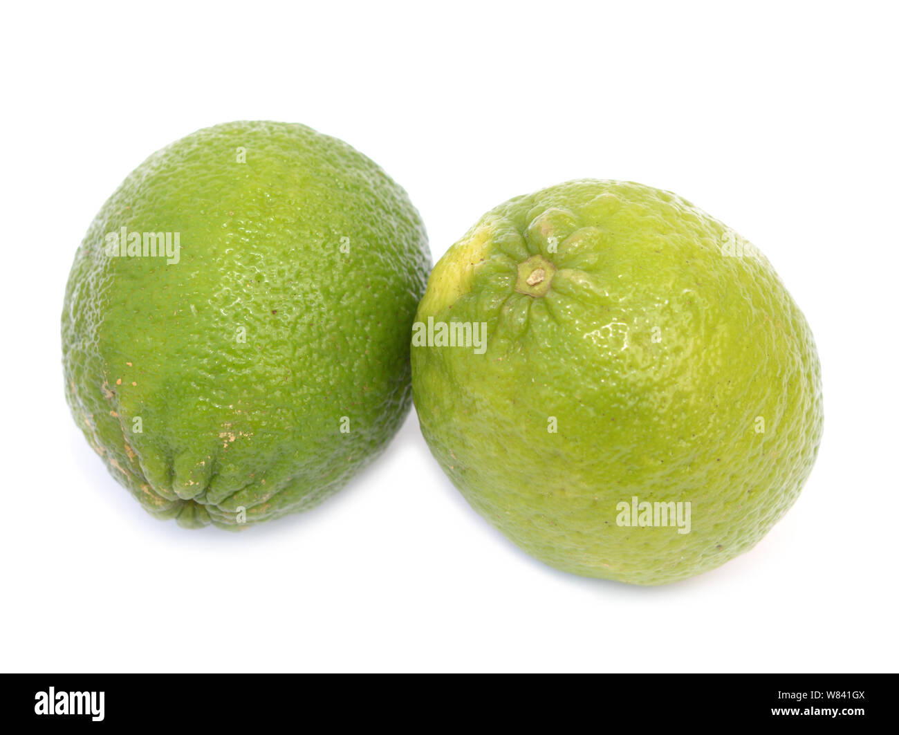 Two limes on white background Stock Photo - Alamy
