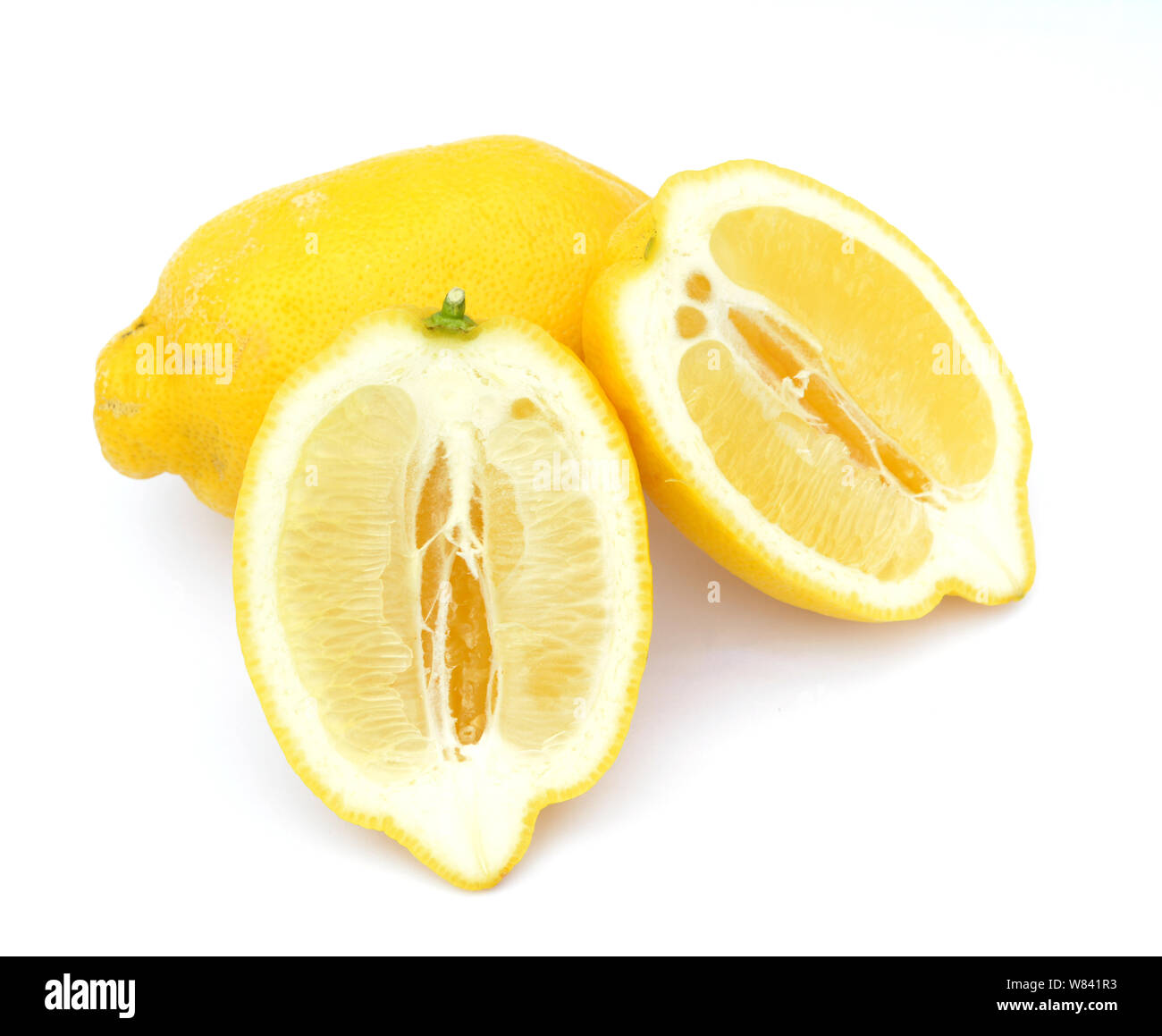 Whole and chopped lemon on white Stock Photo - Alamy