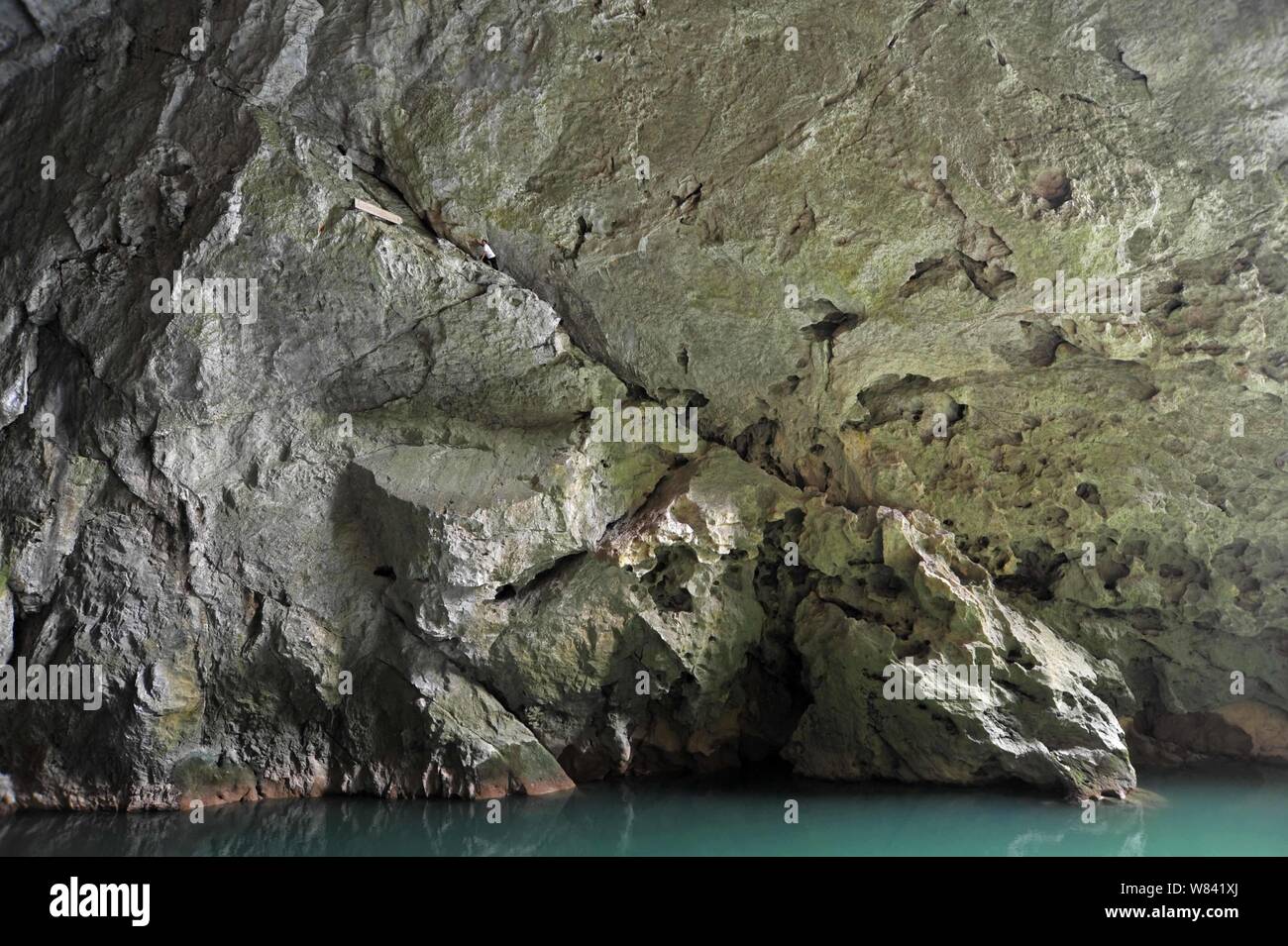 Chinese man Huang Xiaobao of Miao ethnic minority climbs the cliff in a ...