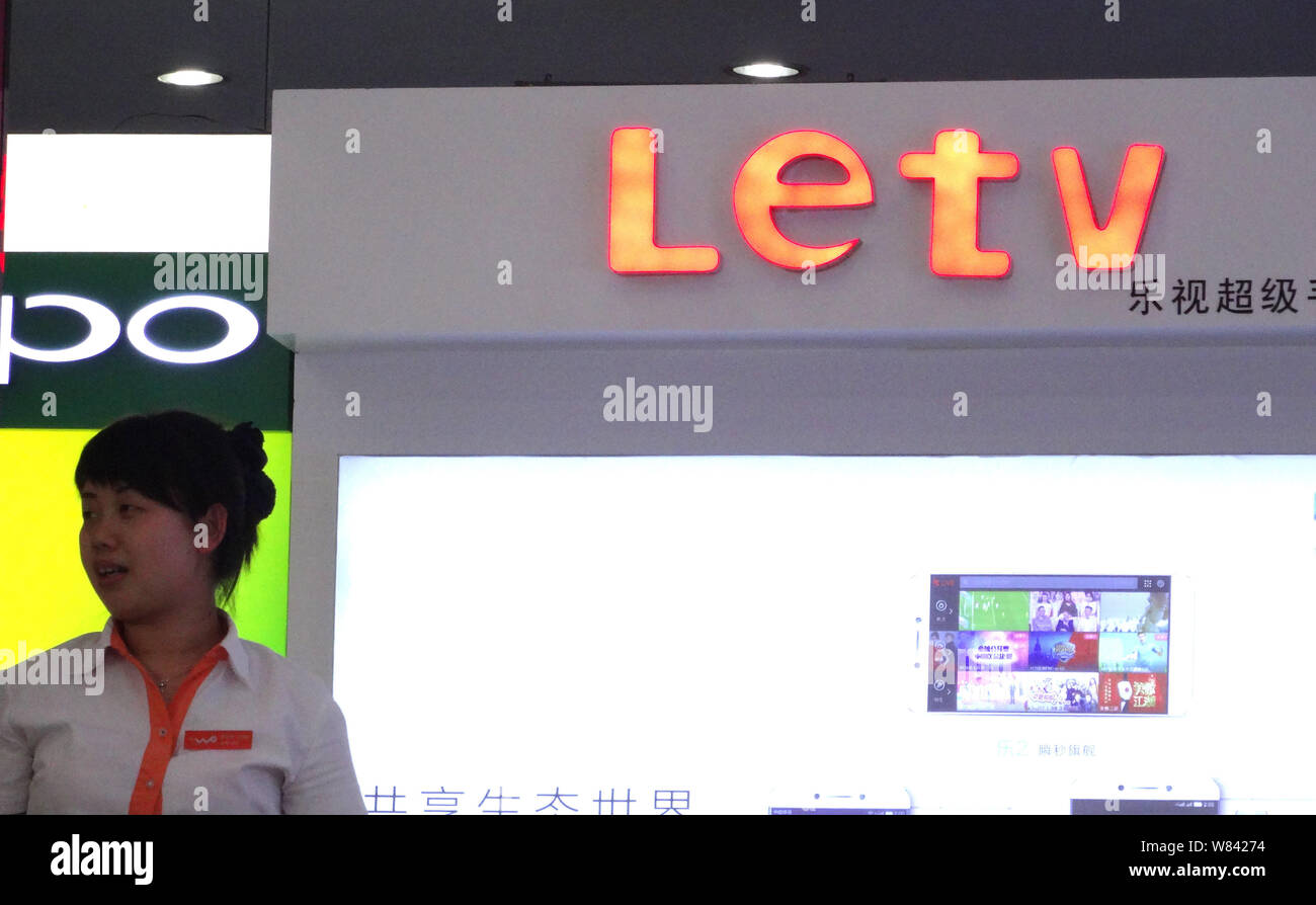 --FILE--A Chinese employee is pictured in front of a logo of Letv, also known as LeEco, at a ...