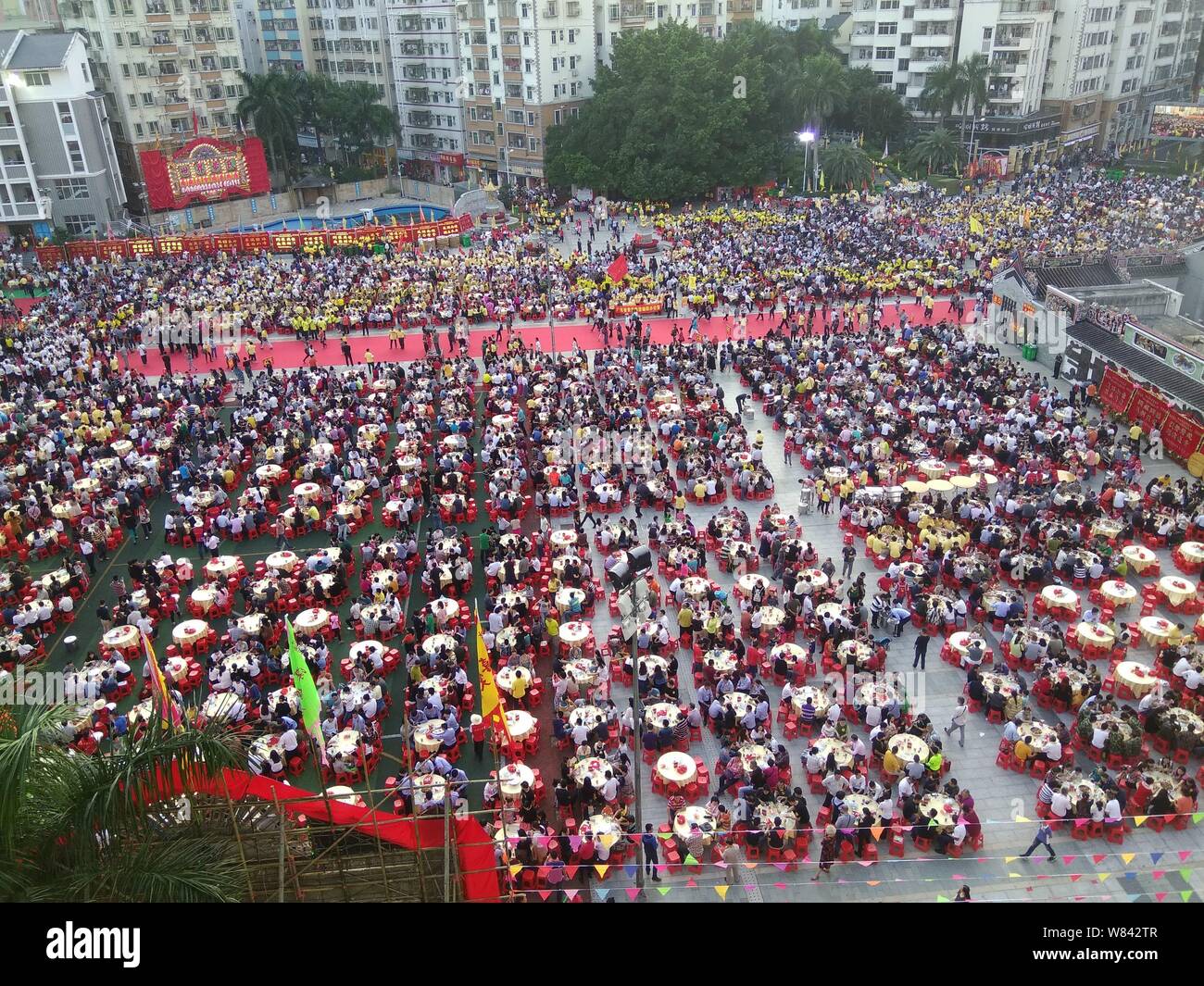 Local residents enjoy food at a poon choi banquet in Xiasha village ...