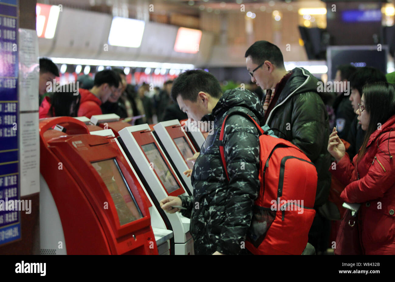 --FILE--Passengers operate automatic boarding machines to get their ...
