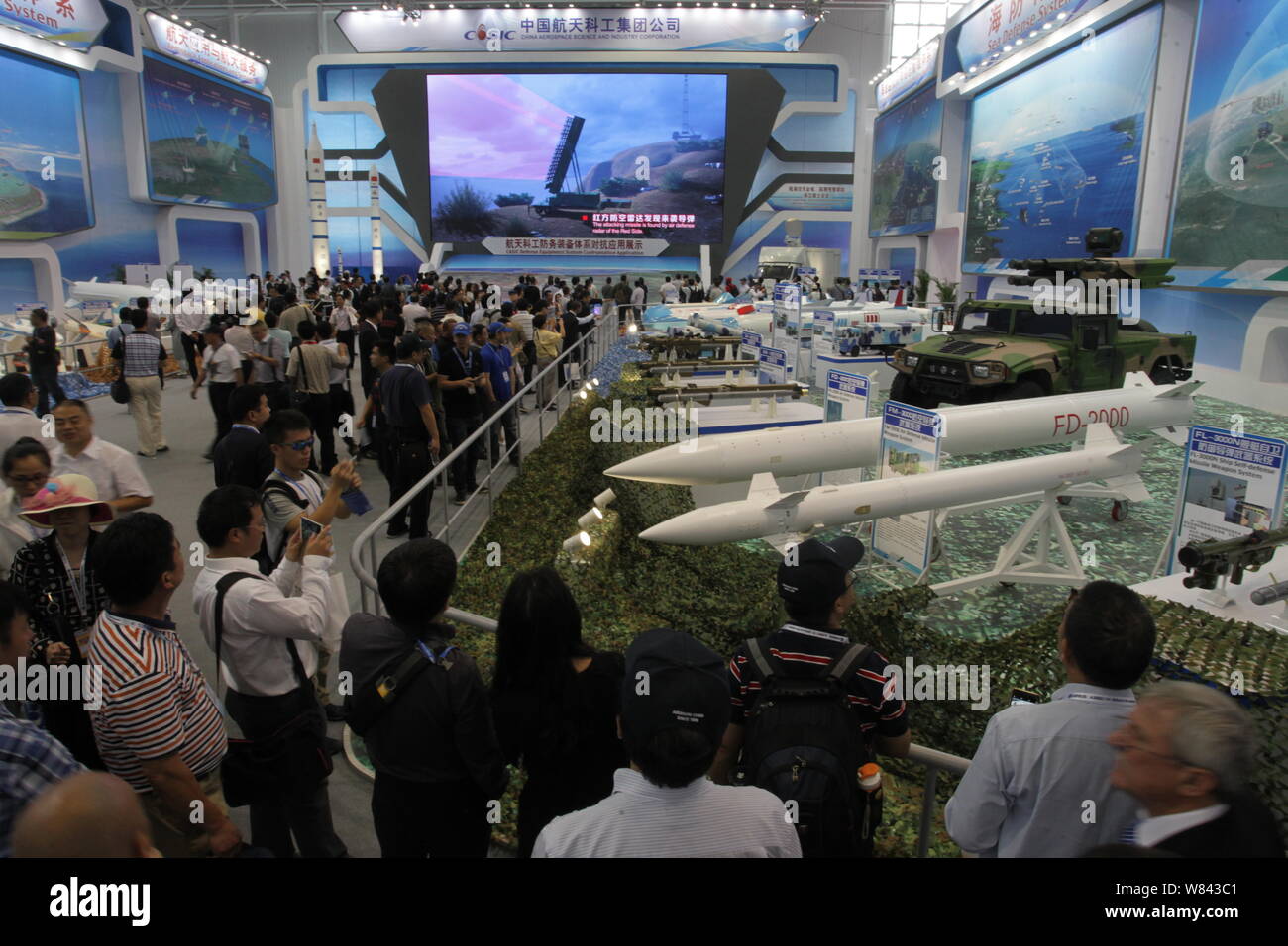 Visitors look at model missiles at the stand of CASIC (China Aerospace ...