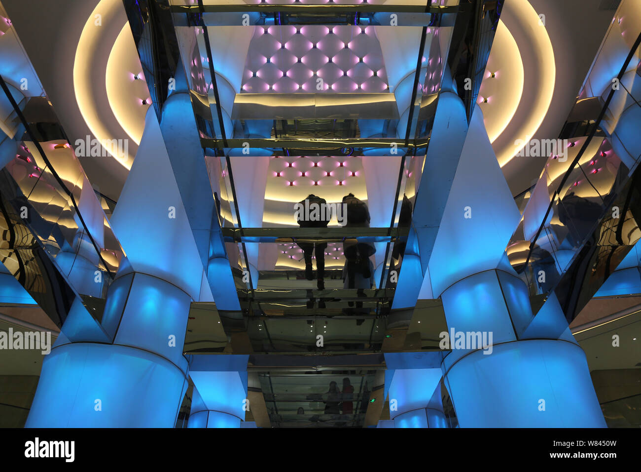 Chinese students walk through a glass bridge in the new library at Sias ...
