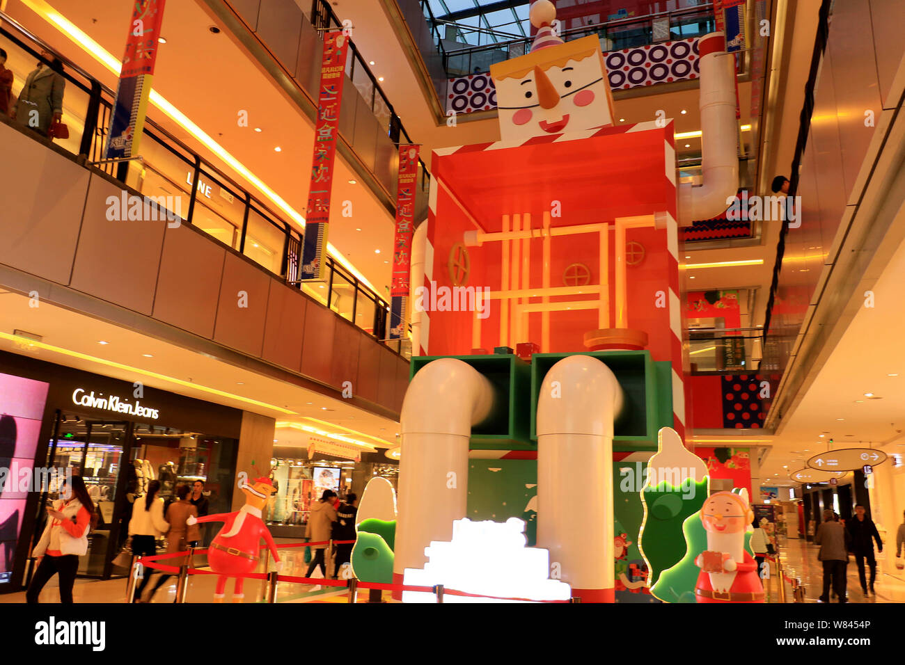 A cartoon figure dressed up like Santa Claus named "MOMO" is displayed ...