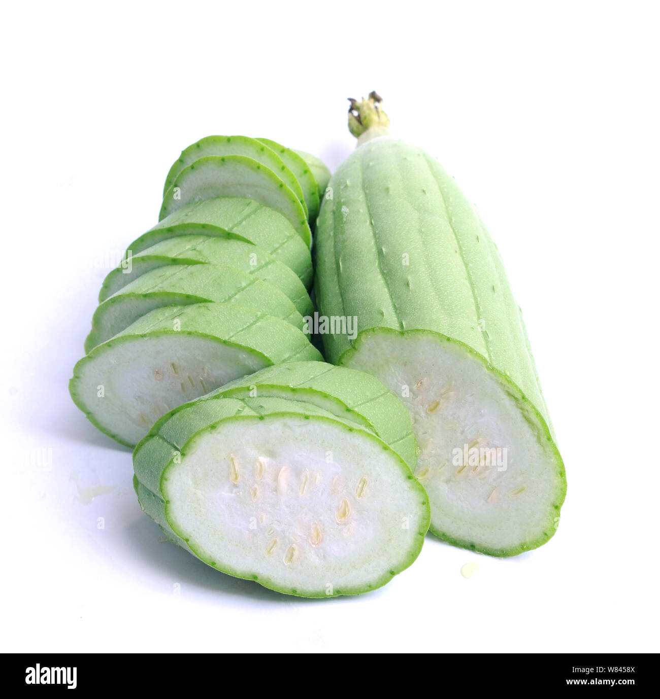 Sliced organic luffa on white background Stock Photo - Alamy